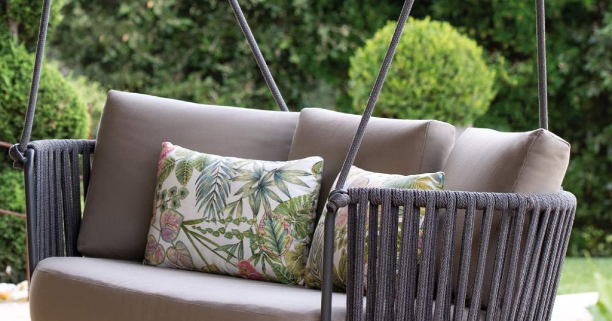 Outdoor swing with black metal structure and rope